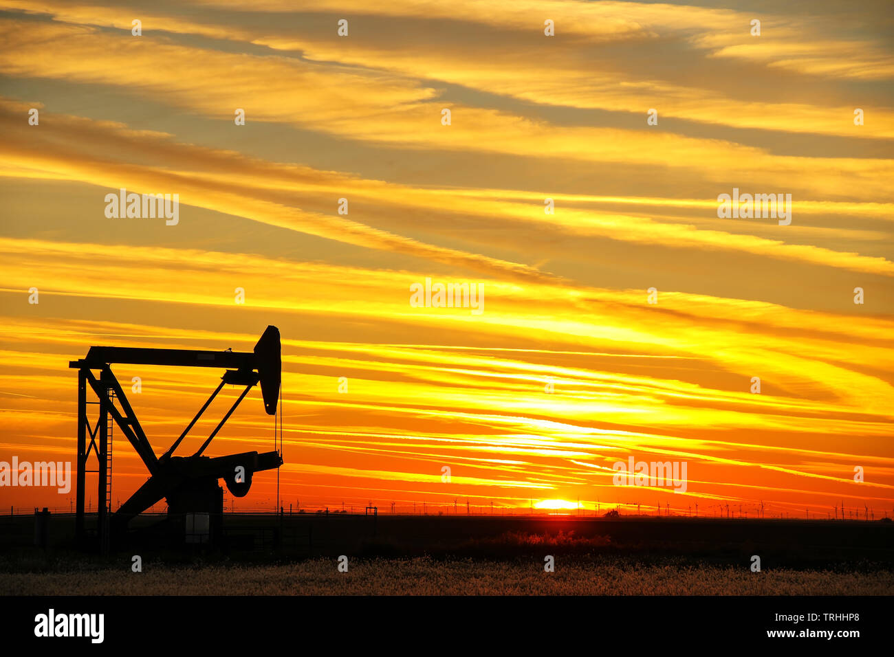 Silhouetted pumpjack in the oil field at sunset Stock Photo - Alamy