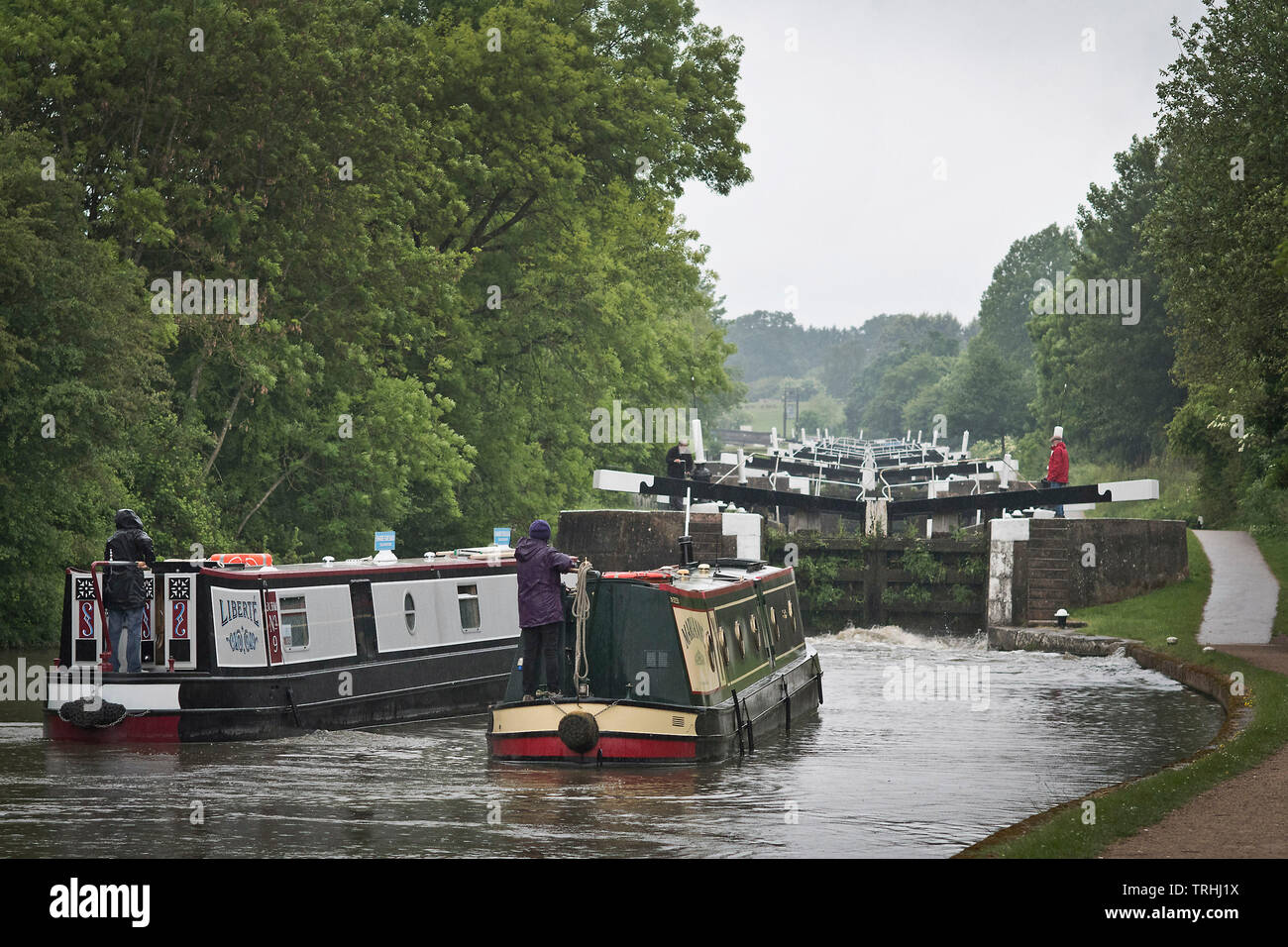 Narrow boats ascend the Hatton Flight, or " "stairway to heaven", a ...