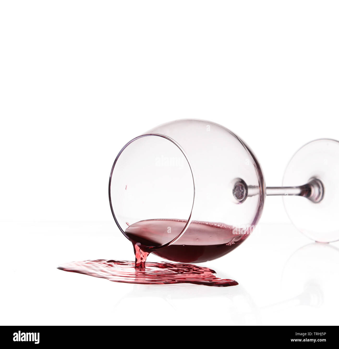 Red wine spilled from glass over white background Stock Photo - Alamy