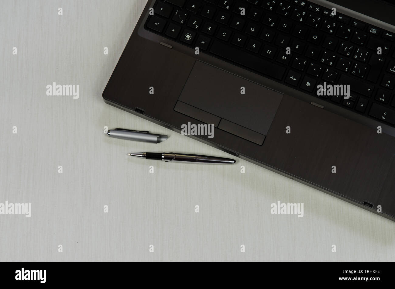 notebook keyboard and pen lying on the table isolated Stock Photo - Alamy