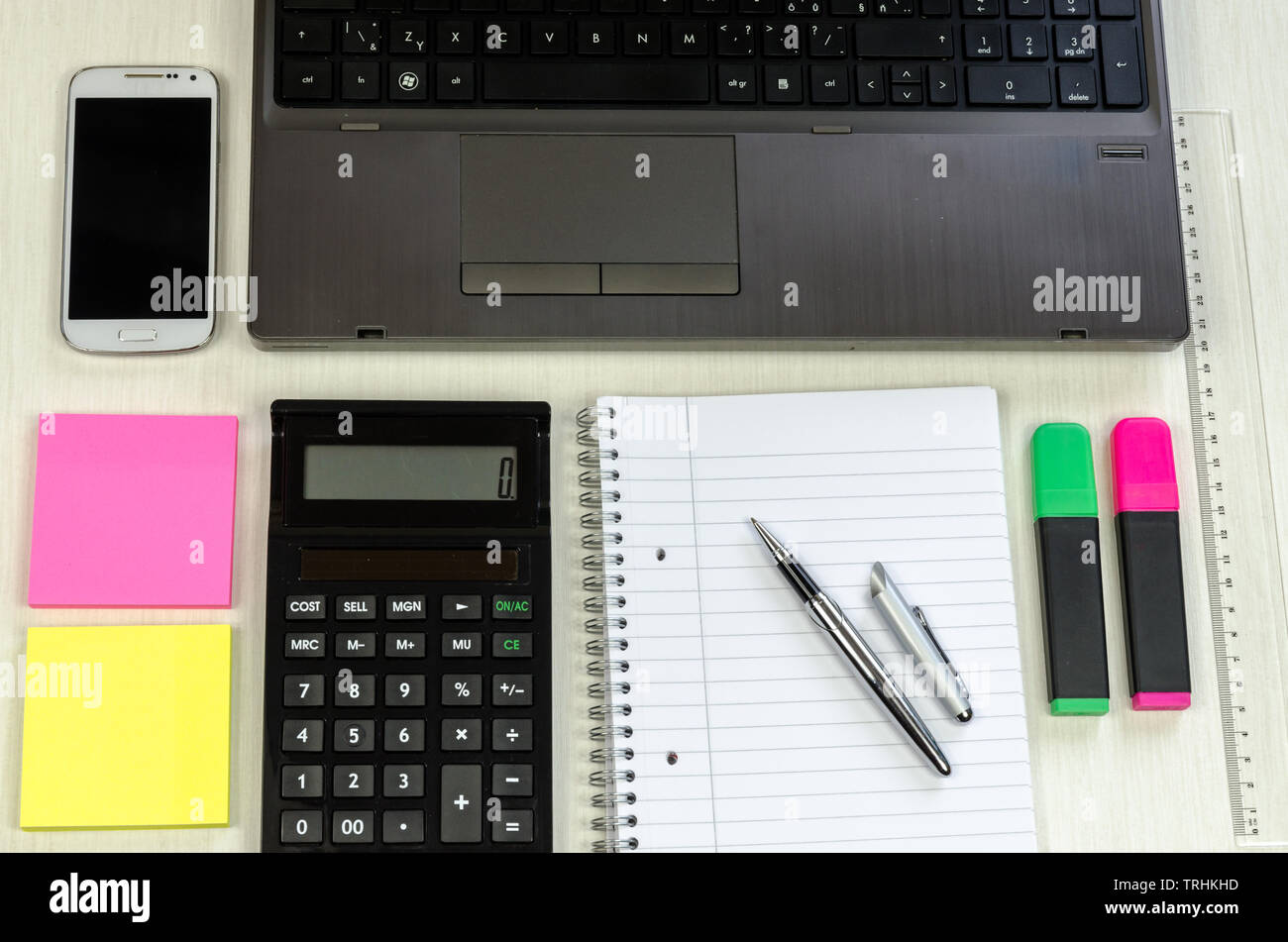 tide office table with laptop, pen, notepad,cup of coffee, smartphone ...