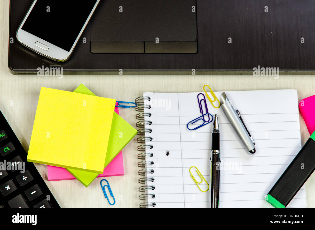 business office table with laptop, pen, notepad, smartphone and ...