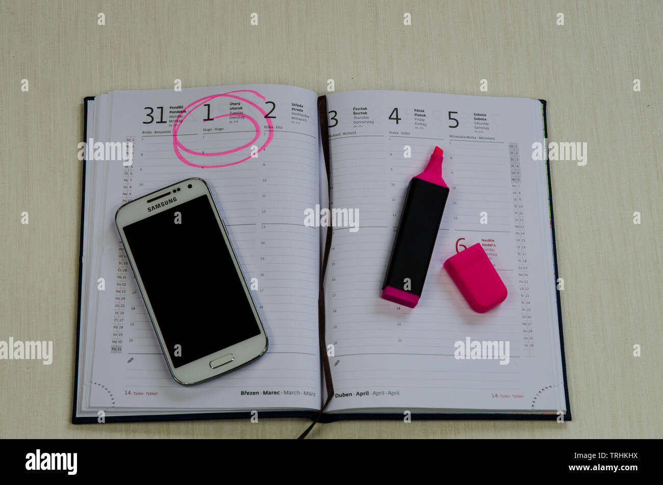 open diary with marked date, mobile phone and red marker Stock Photo ...