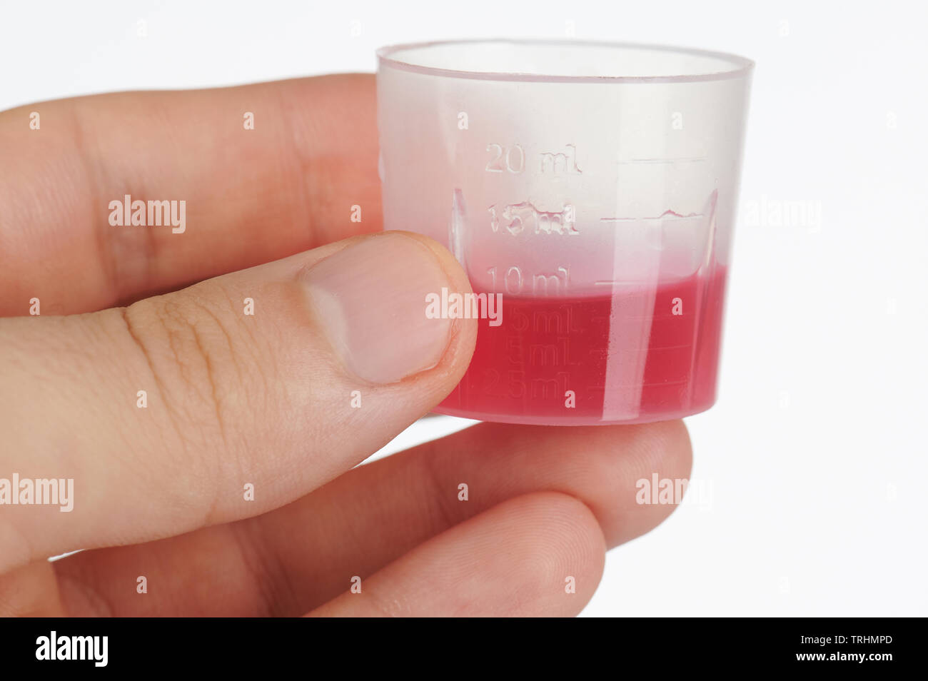 Hand hold plastic cup with mixture close up isolated Stock Photo - Alamy