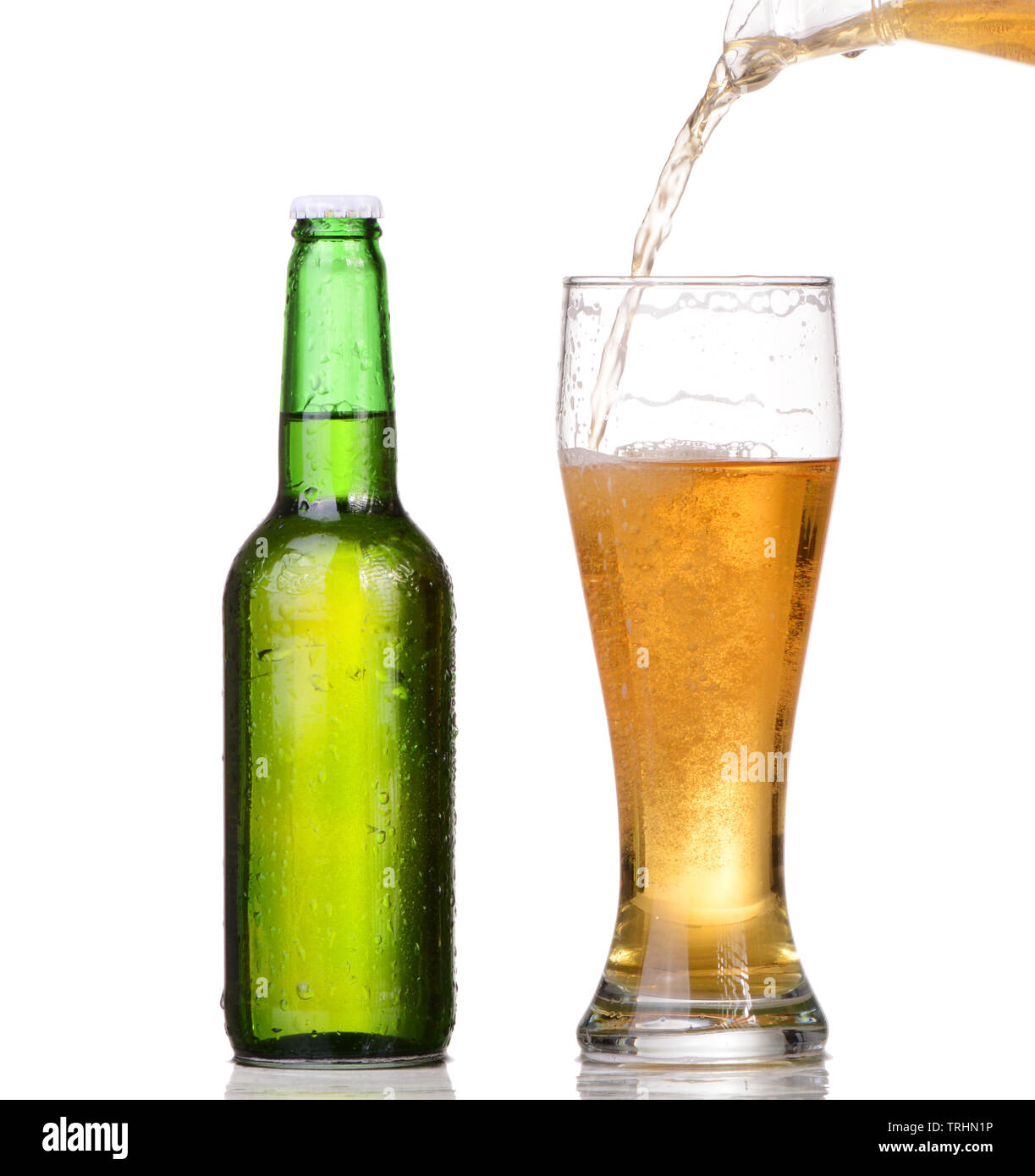 Pouring beer from bottle isolated on white background Stock Photo - Alamy