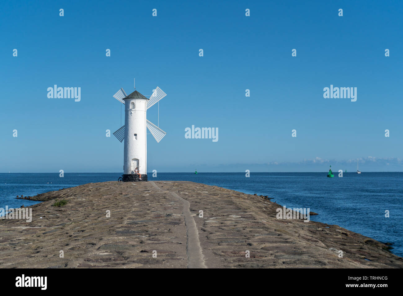 the White Lighthouse in Swinoujscie stands tall as a timeless beacon on ...
