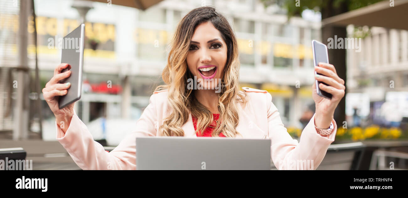 Hysterical young woman with too many screens, mobile phones, tablets ...