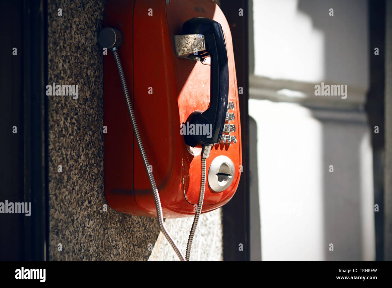 Street red retro telephone, available for everyone, which illuminates ...