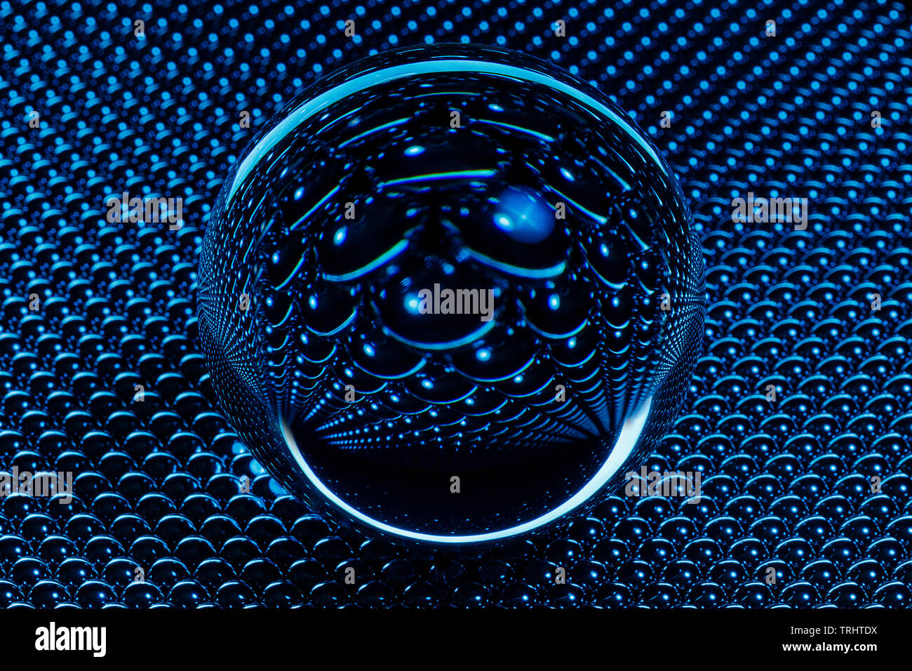 A large Glass Sphere resting on a field of tiny steel spheres ...