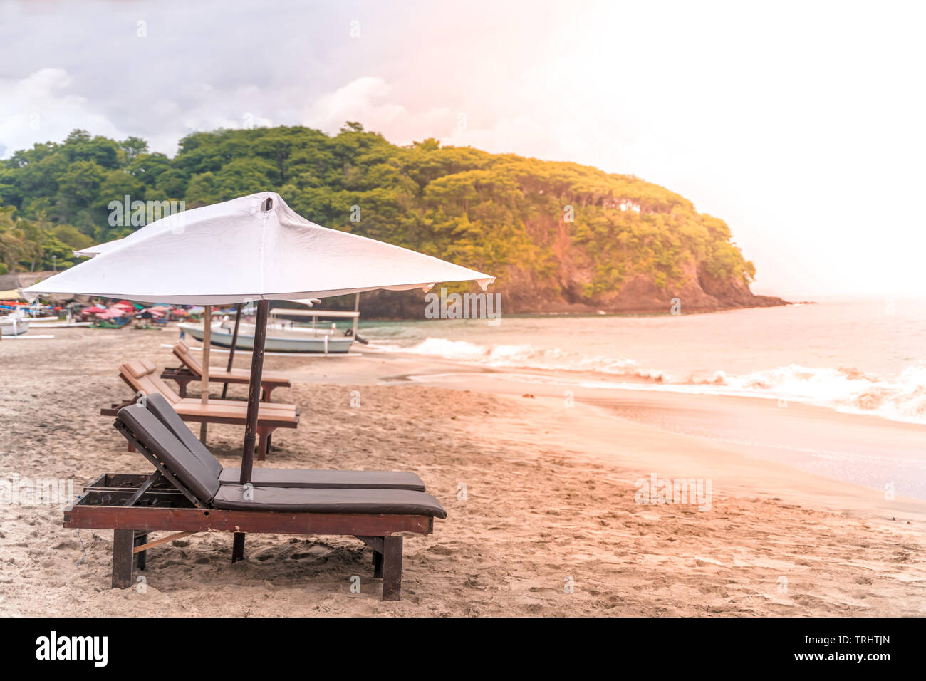 Empty sunbeds waiting for tourists on Virgin beach or Pasir Putih or ...