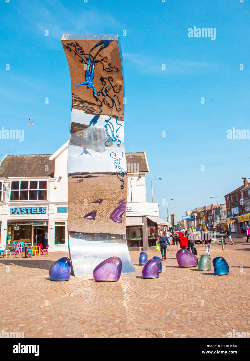 The Wave a stainless steel sculpture with a figure diving into it from ...