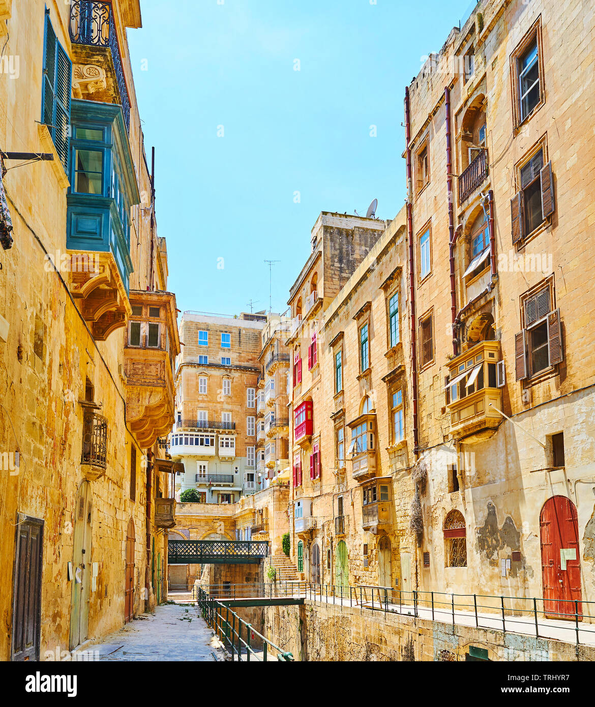 The shady Lvant street with old high living buildings, Valletta, Malta ...