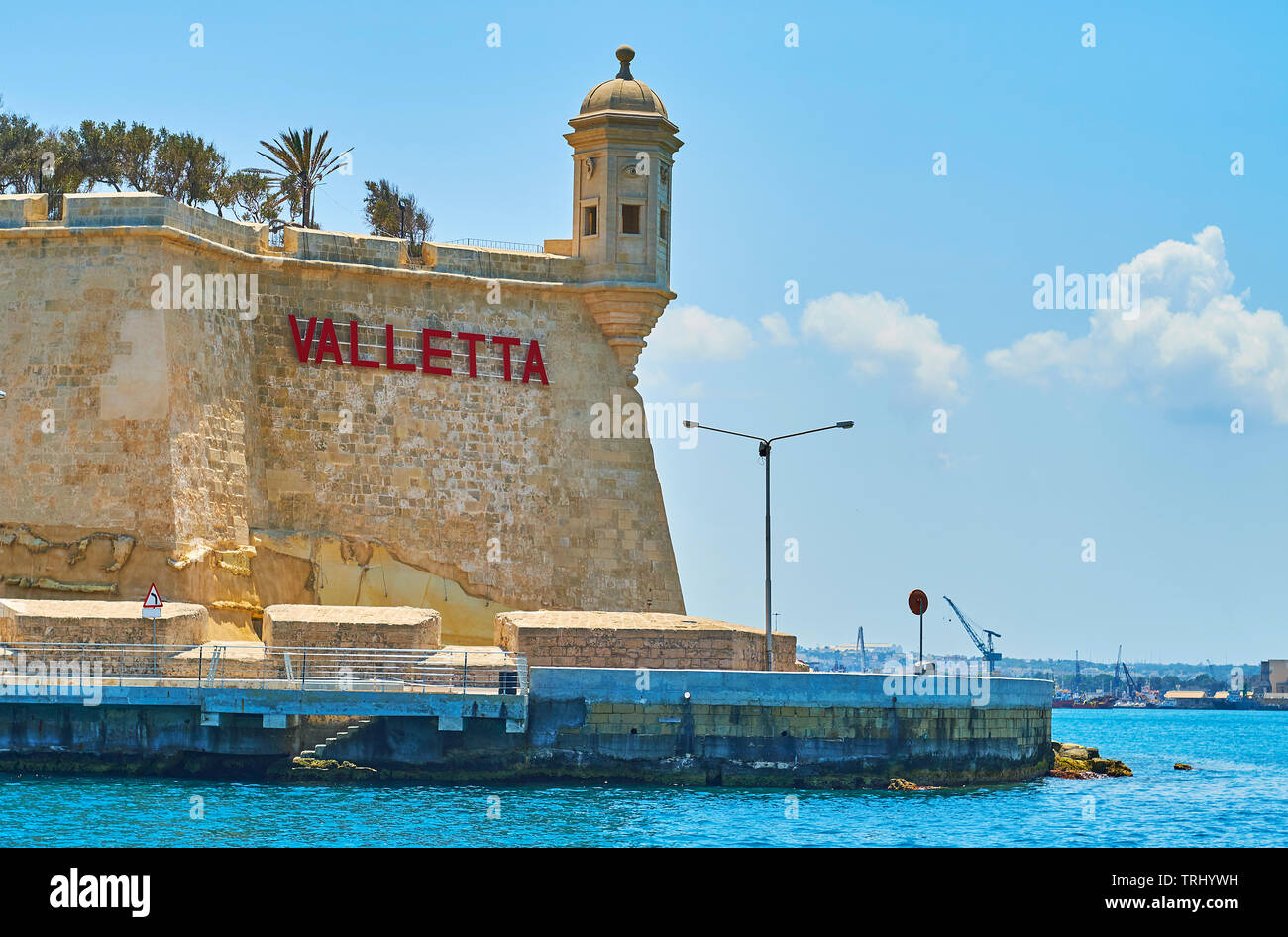 The huge stone wall of Senglea (L-Isla) fortress with small Guard Tower ...