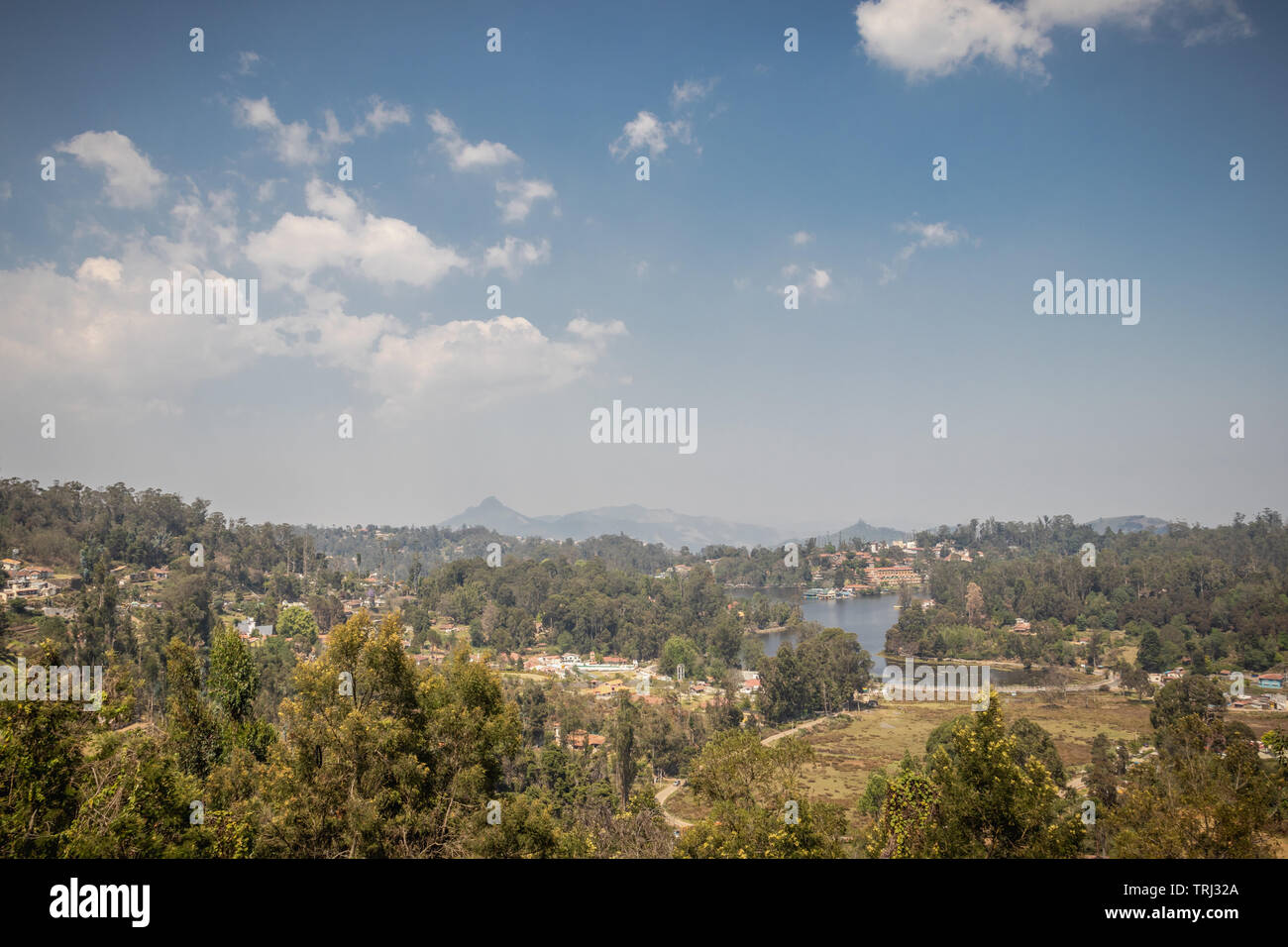 This is the upper lake view with green forest and blue sky. This image ...