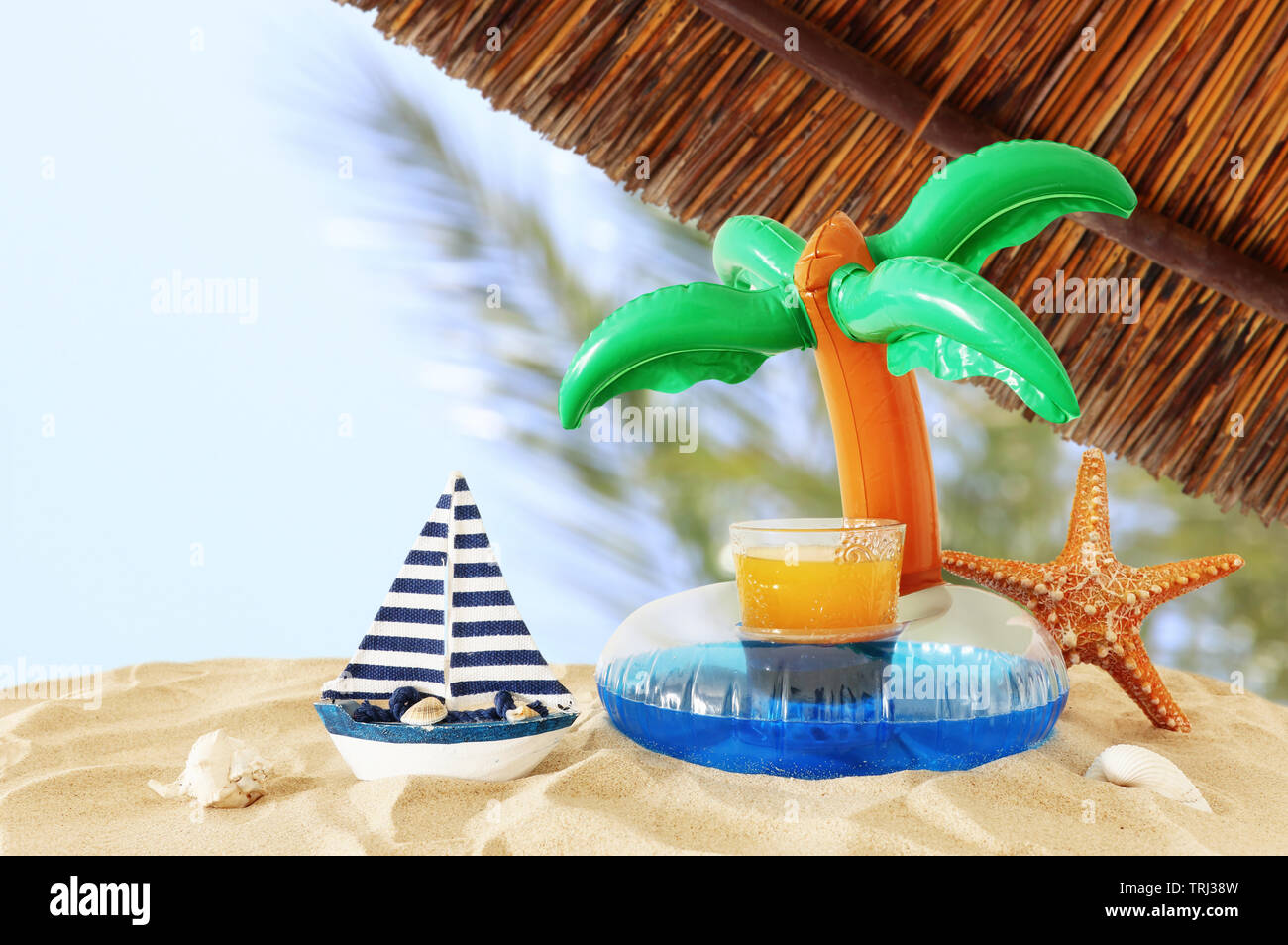 vacation and summer concept with fresh fruit drink and palm shape pool ...