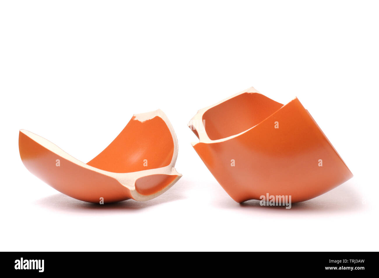 Broken orange plate isolated on white background Stock Photo - Alamy