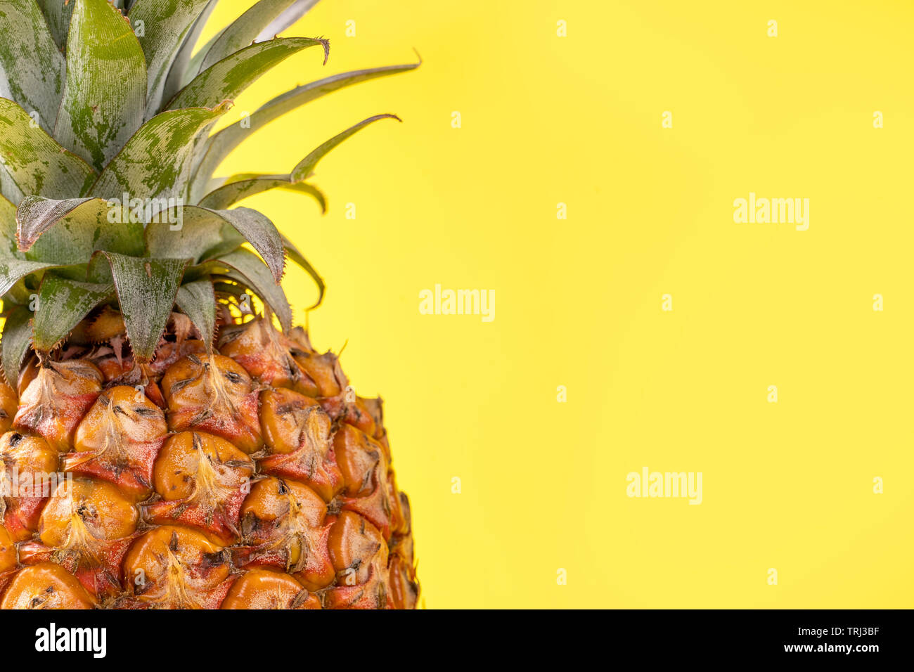 Beautiful fresh pineapple isolated on bright yellow background, summer ...