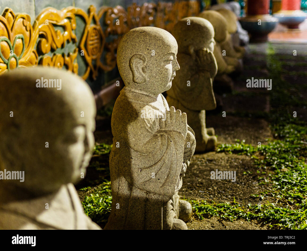 SINGAPORE, 18 MAY 2019 – Close-up side view of a row of stone Buddhist ...
