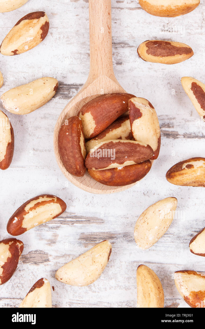 Heap of brazil nuts with wooden spoon on old rustic board, healthy ...