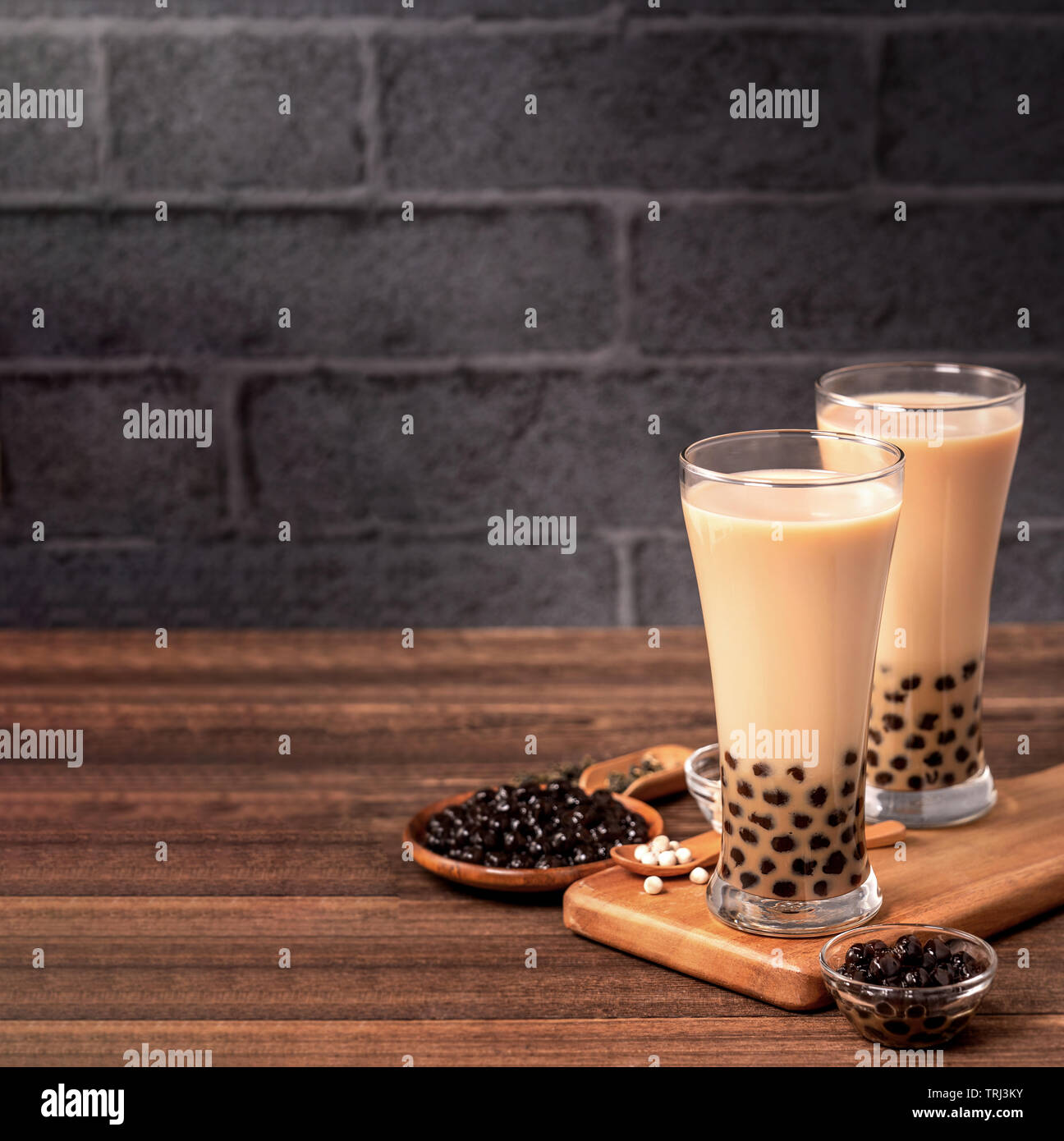 Delicious bubble milk tea with tapioca pearl ball in glass on wooden ...