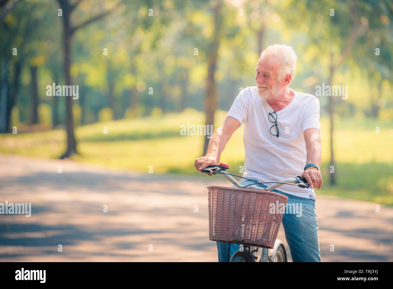 Elderly man riding bicycle bike ride exercise park cycle hi-res stock ...