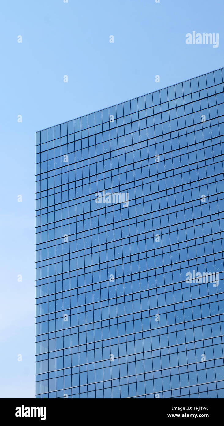 Tall high rise building with with a whole wall of glass window panels ...