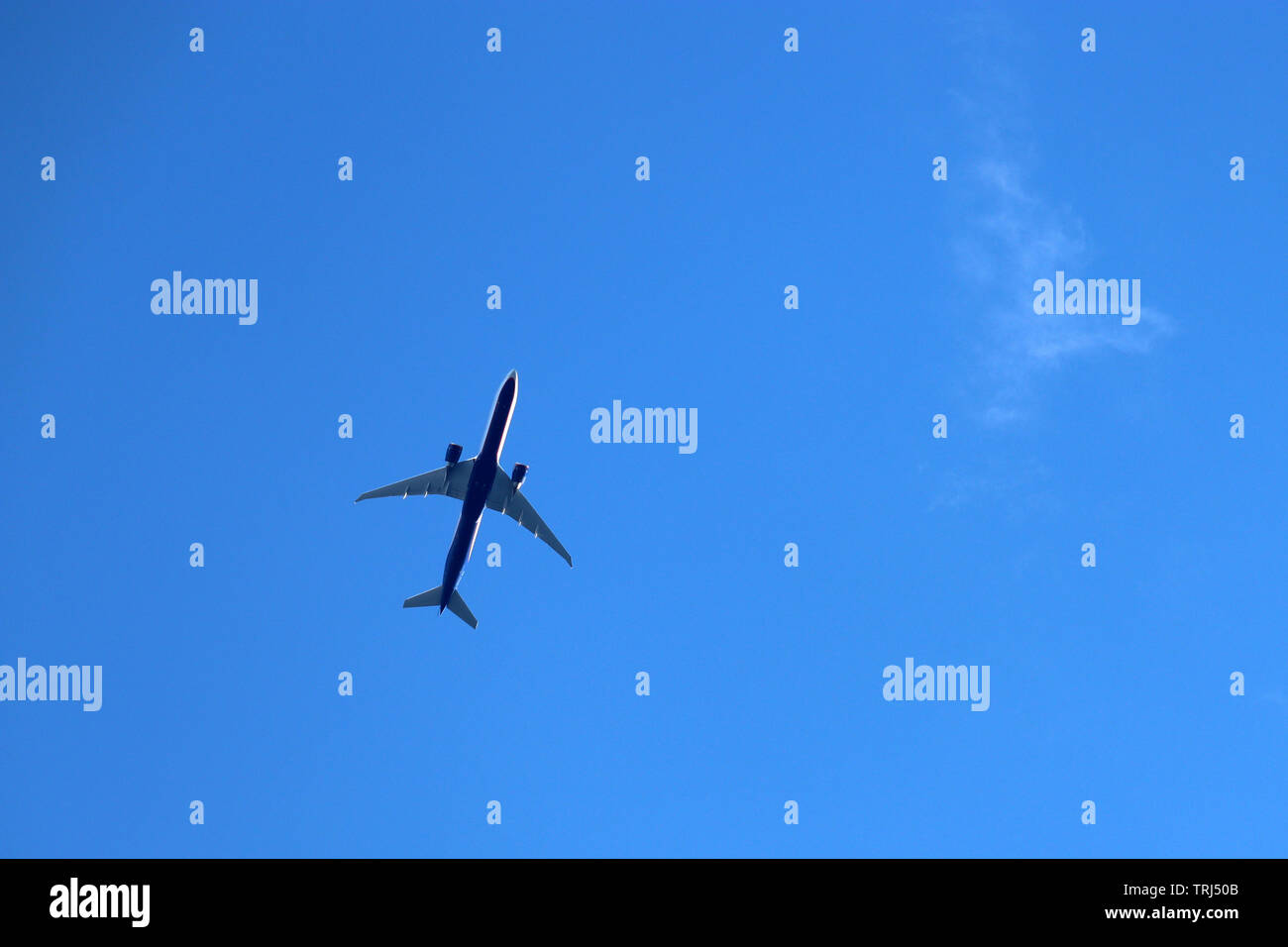 Airplane in the clear blue sky. Commercial jet plane in a flight close ...