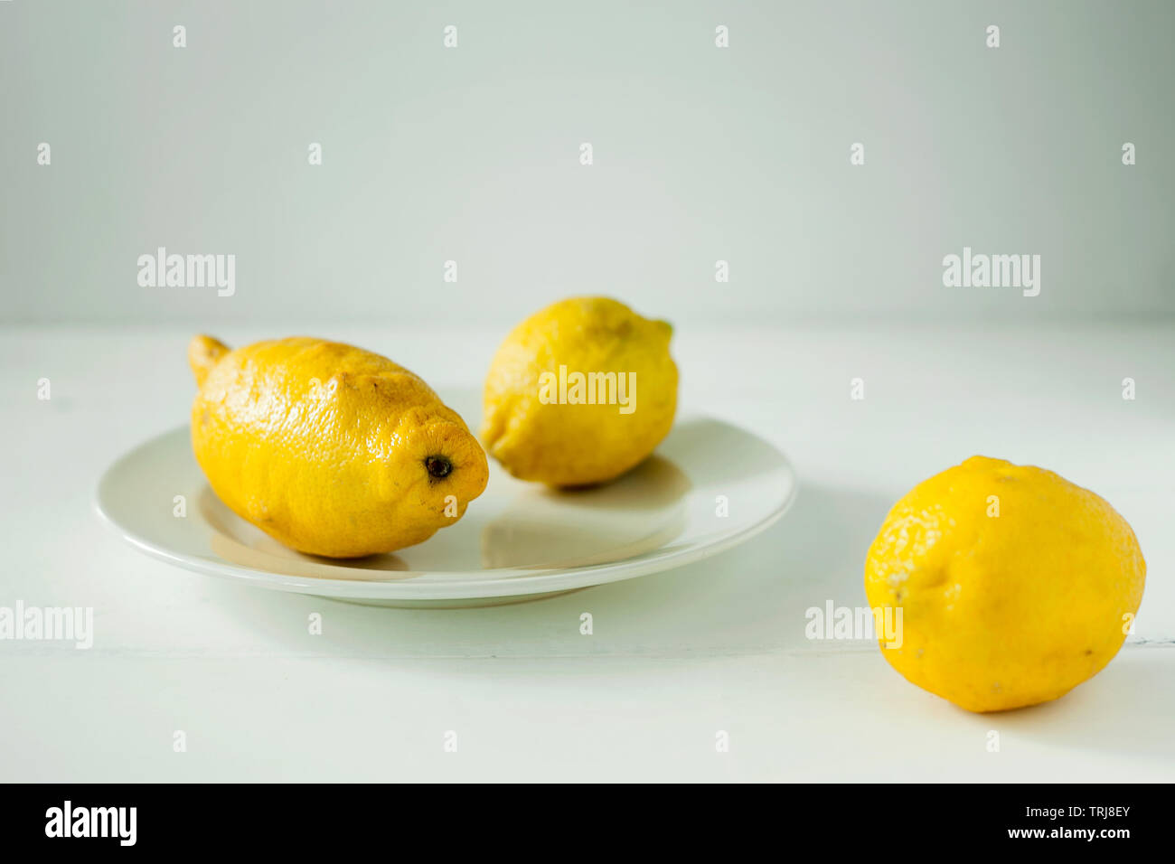 Trendy ugly organic three lemons unusual shape on white background ...