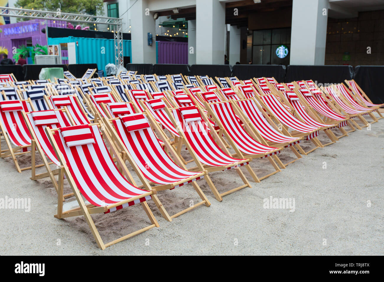 Rows of red white stripe beach chair and blue white stripe beach chair ...