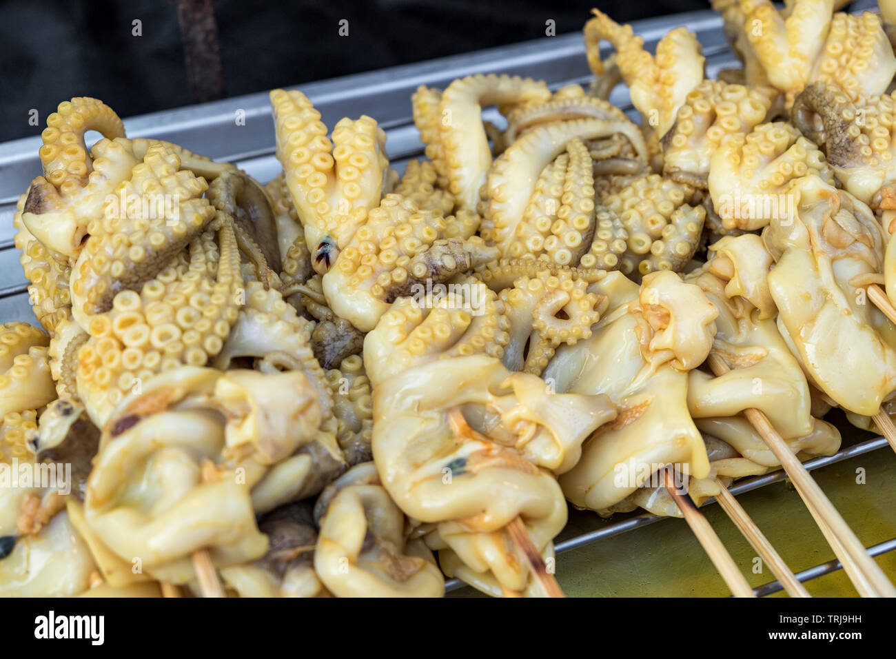 Fresh squid yellow stab arranged on tray Stock Photo - Alamy