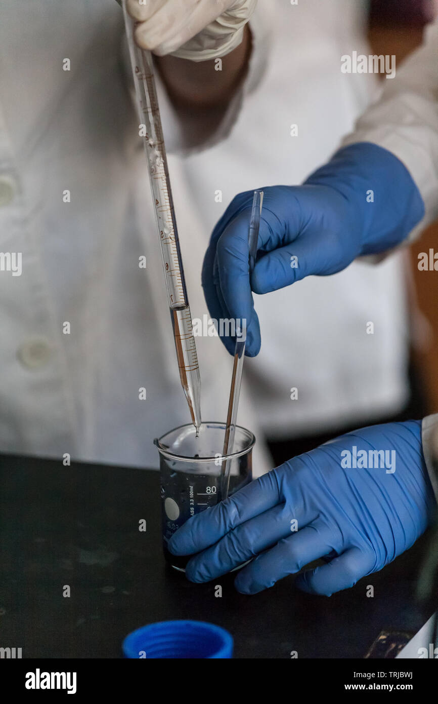 Working in a research chemistry biology lab laboratory making ...