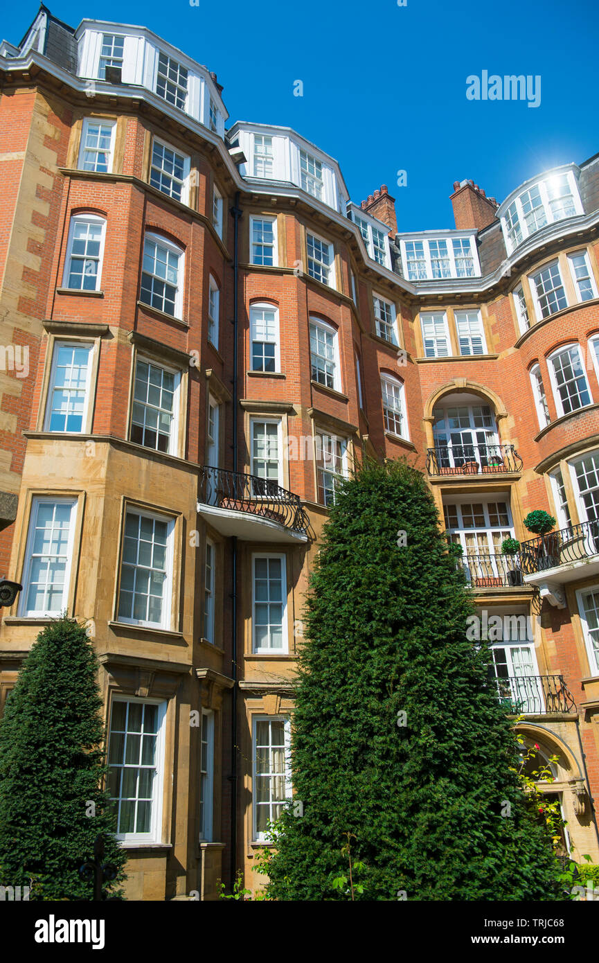 Bright scenic view of traditional red brick architecture in a posh ...