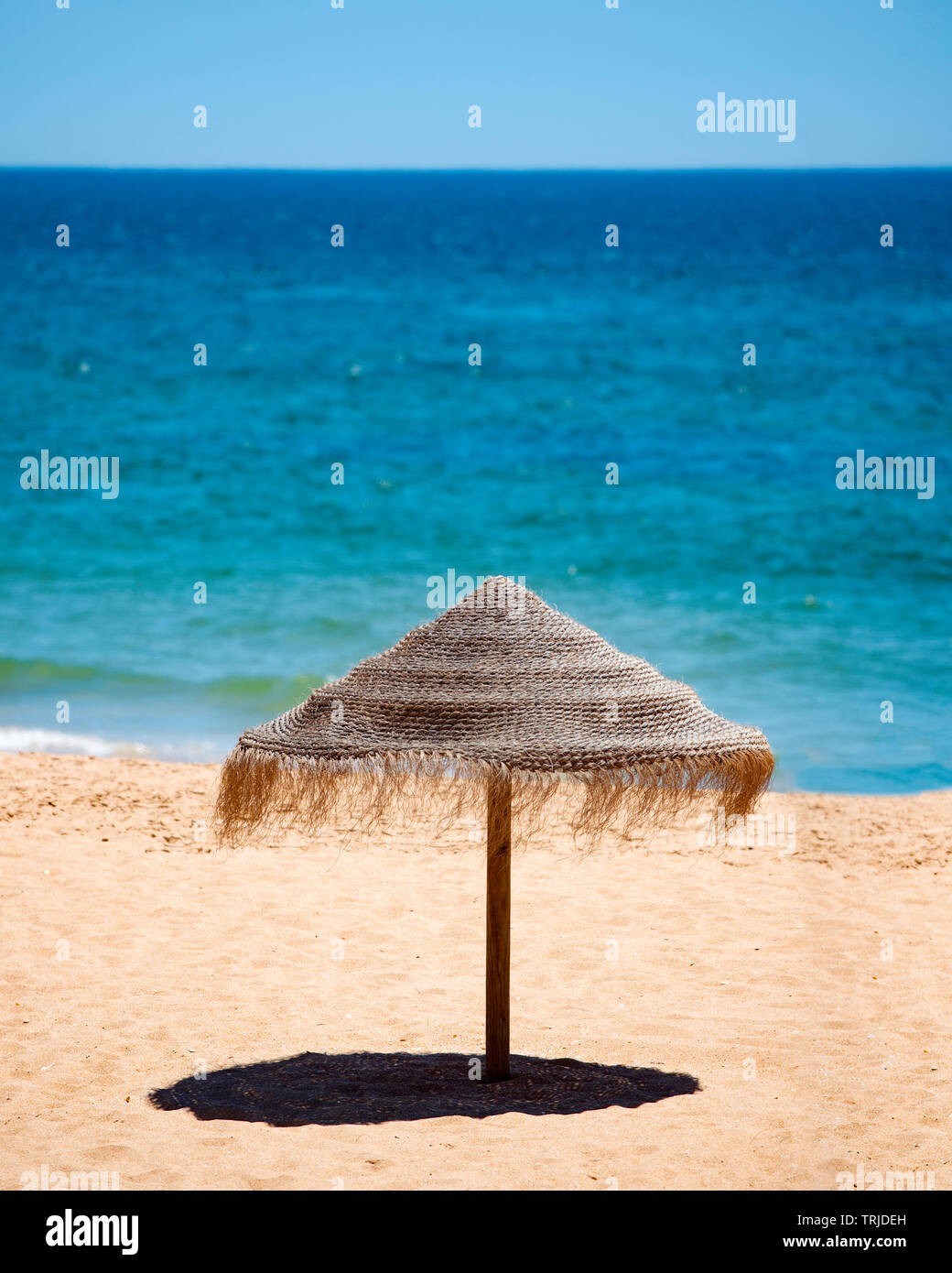 Parasol on a sandy beach Stock Photo - Alamy
