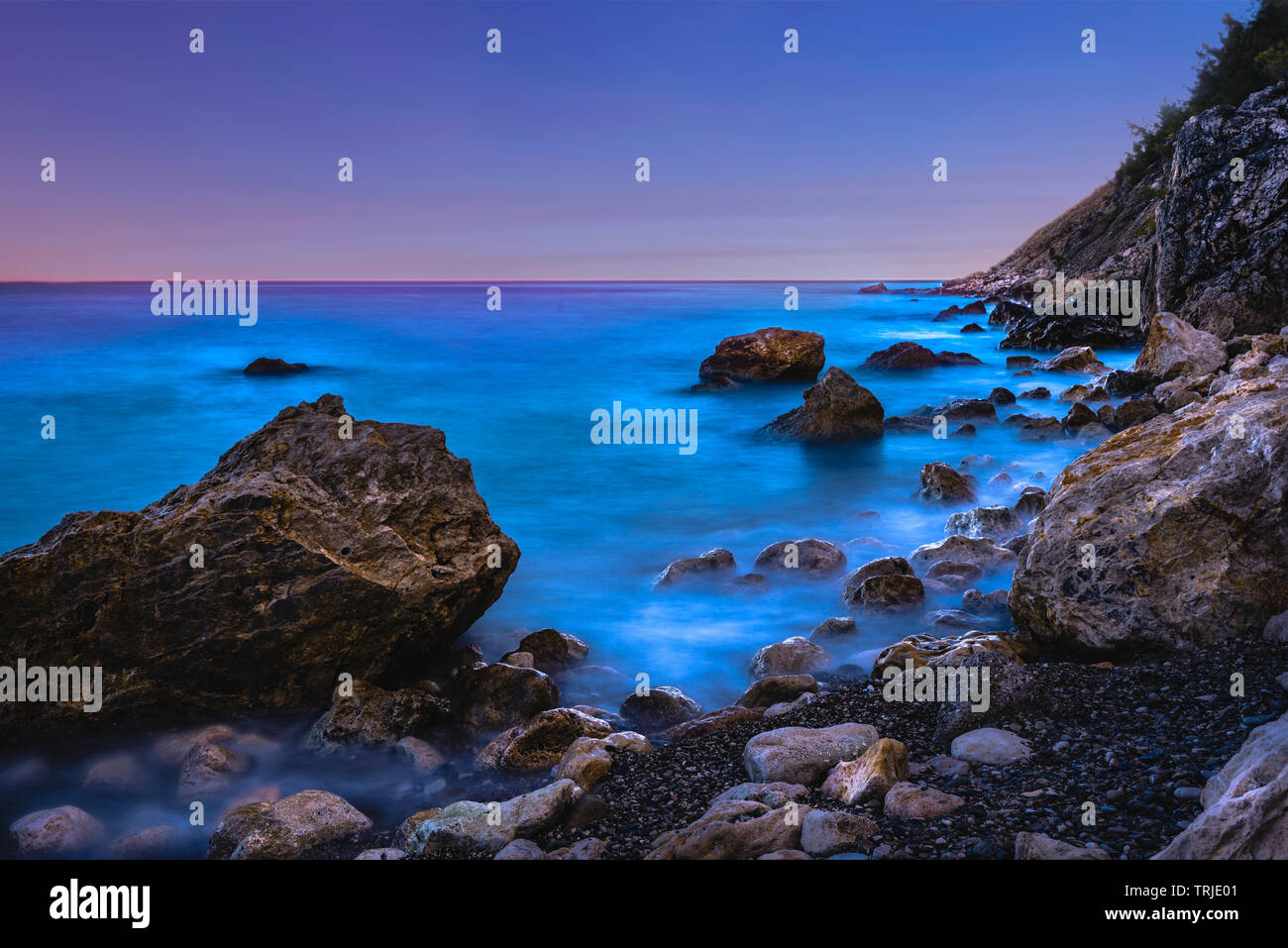 Long exposure image of Dramatic sky seascape with rock in sunset ...