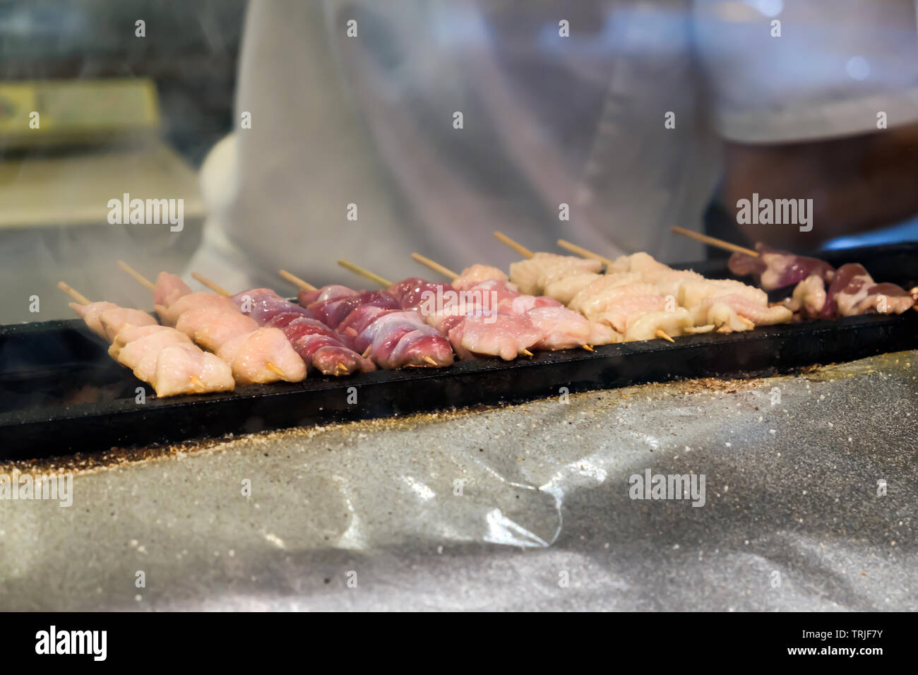 Grilled raw pork,beef and chicken on stove grill in street food wayside ...