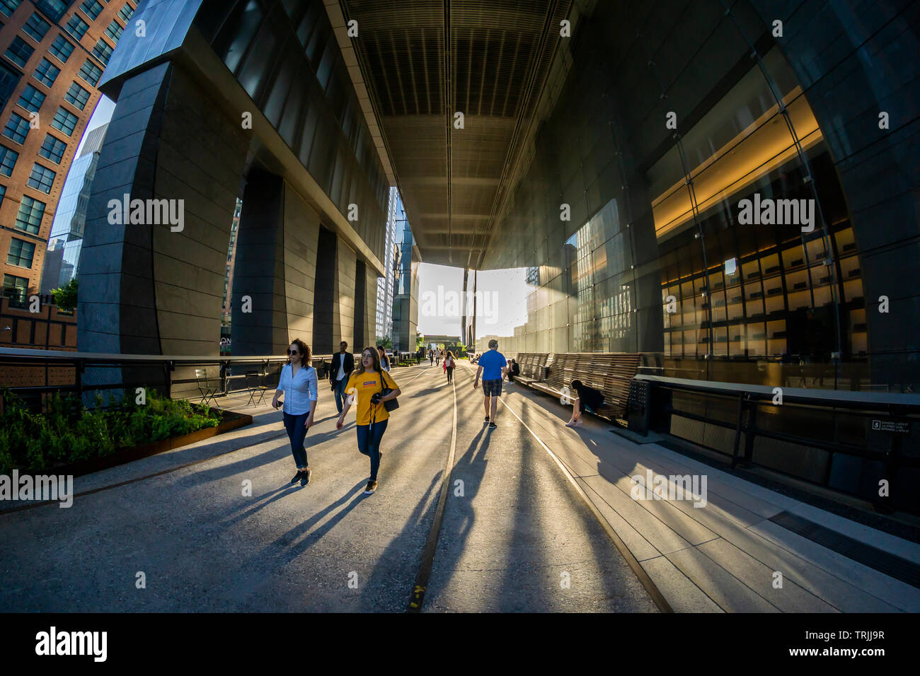 Visitors to the High Line walk through the “Coach Passage” in the newly ...