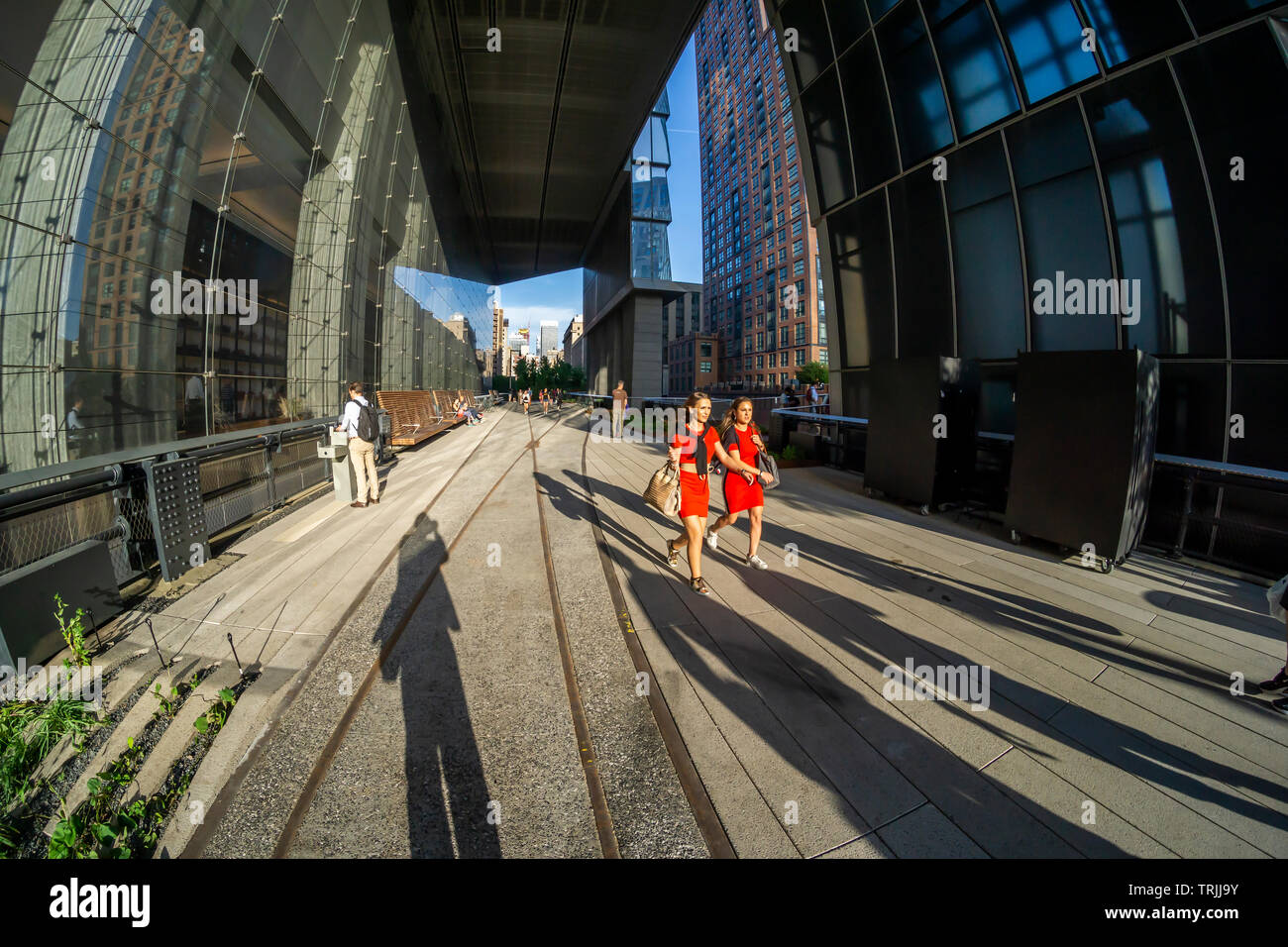 Visitors to the High Line walk through the “Coach Passage” in the newly ...