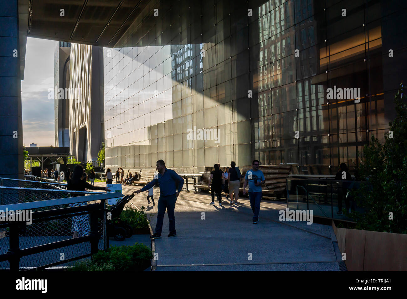 Visitors to the High Line walk through the “Coach Passage” in the newly ...