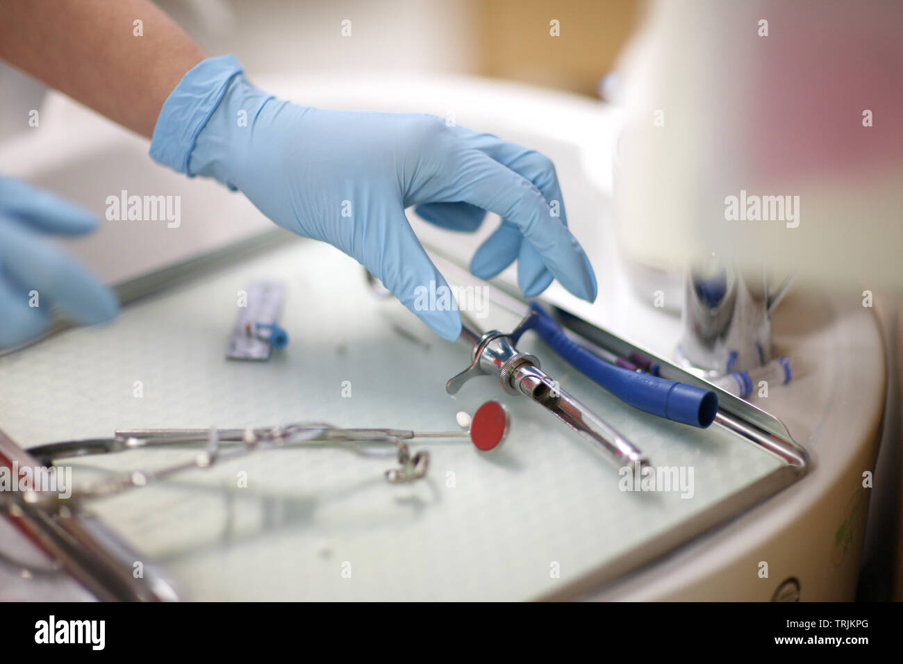 Doctor hands over the table with a dental tool Stock Photo - Alamy