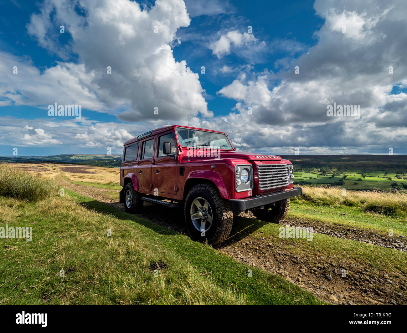 Red Land Rover Defender 110 4WD car navigating a Green Lane track ...