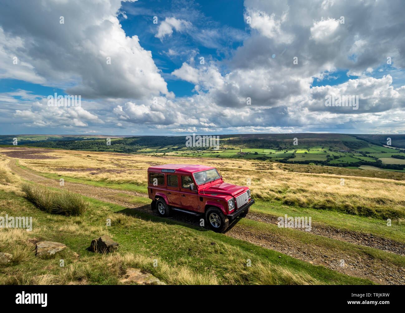 Red Land Rover Defender 110 4WD car navigating a Green Lane track ...