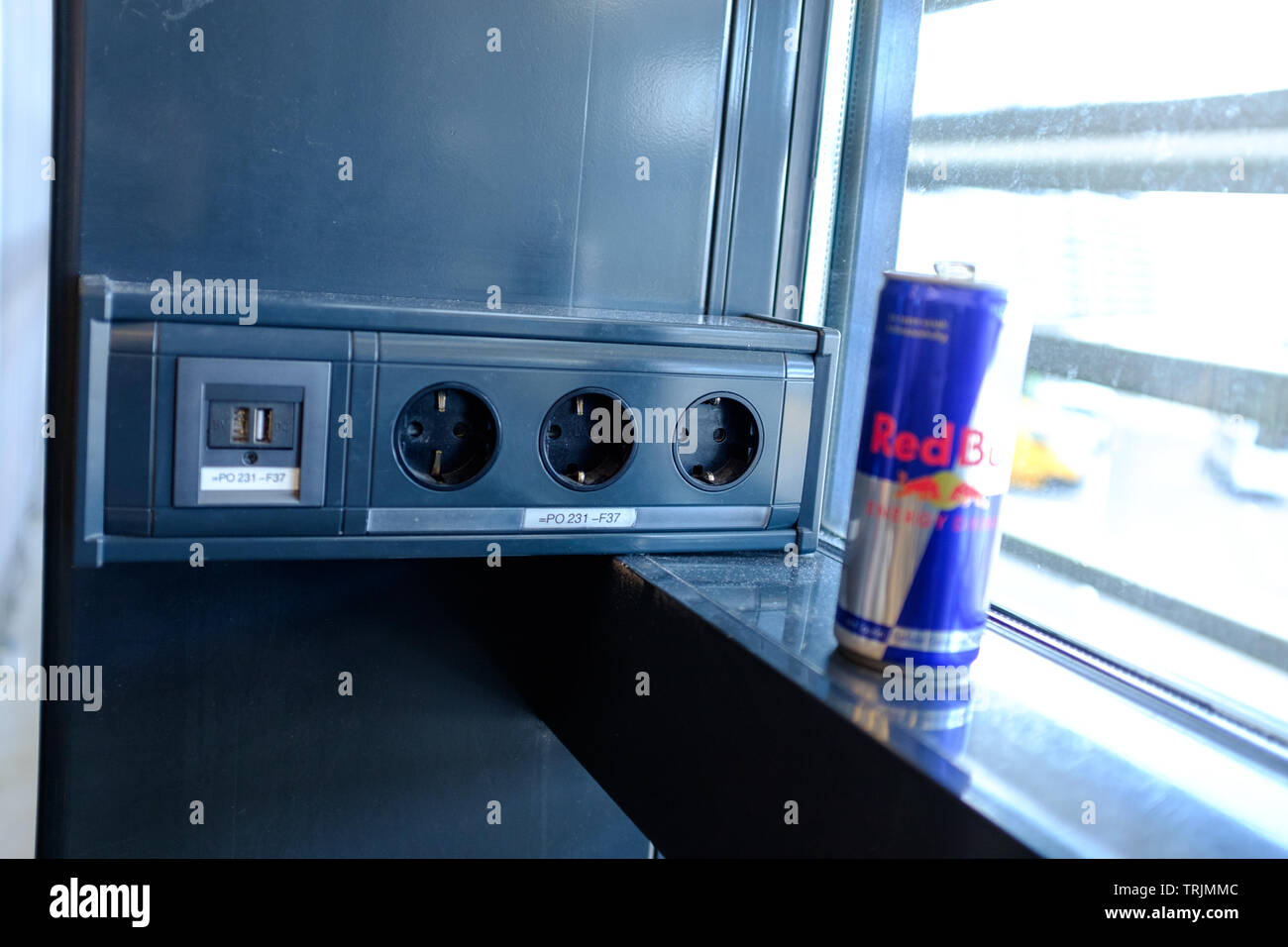 Power sockets next to a can of energy drink Red Bull Stock Photo - Alamy