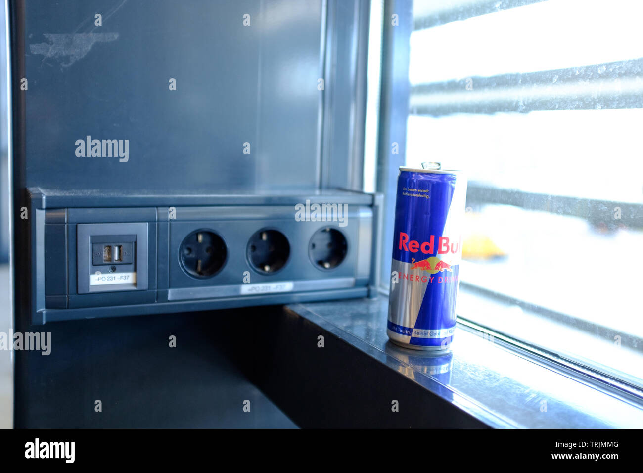 Power sockets next to a can of energy drink Red Bull Stock Photo - Alamy