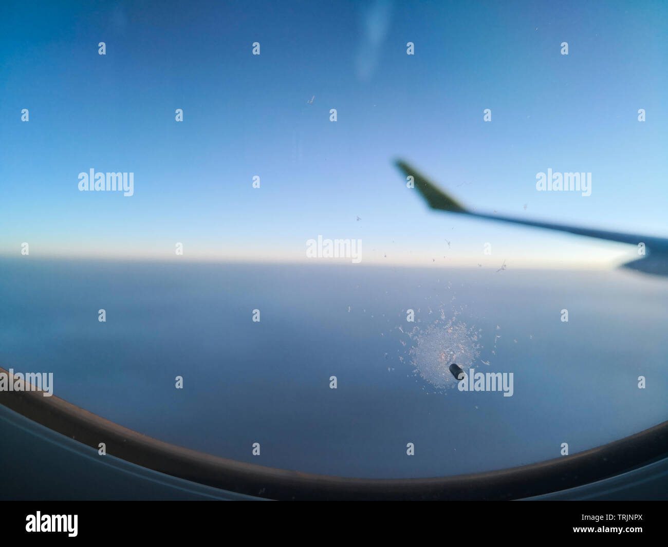 Color close up shot of a little hole in the window of a passenger ...