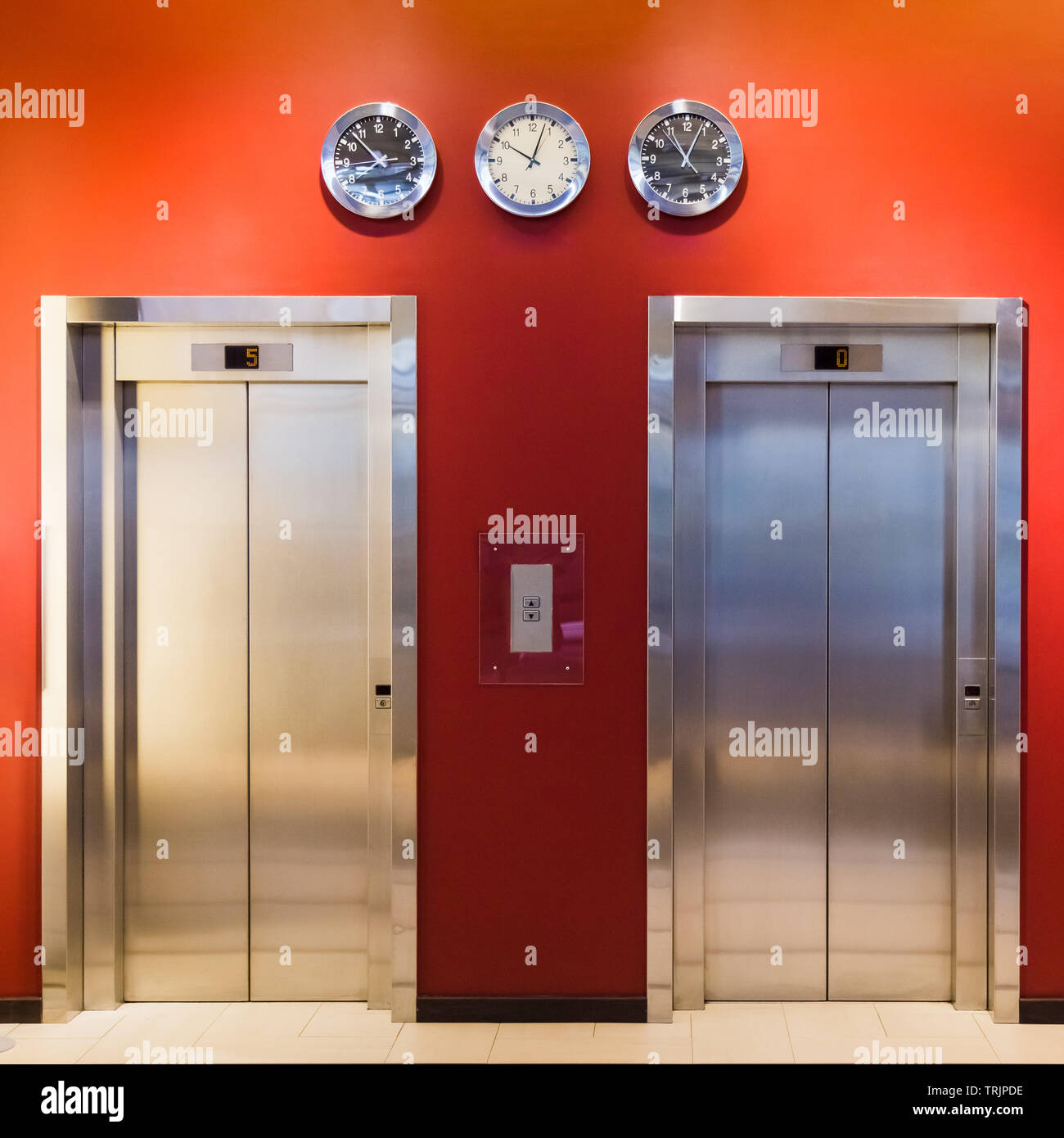 Two elevators and three clocks showing different time zones Stock Photo ...