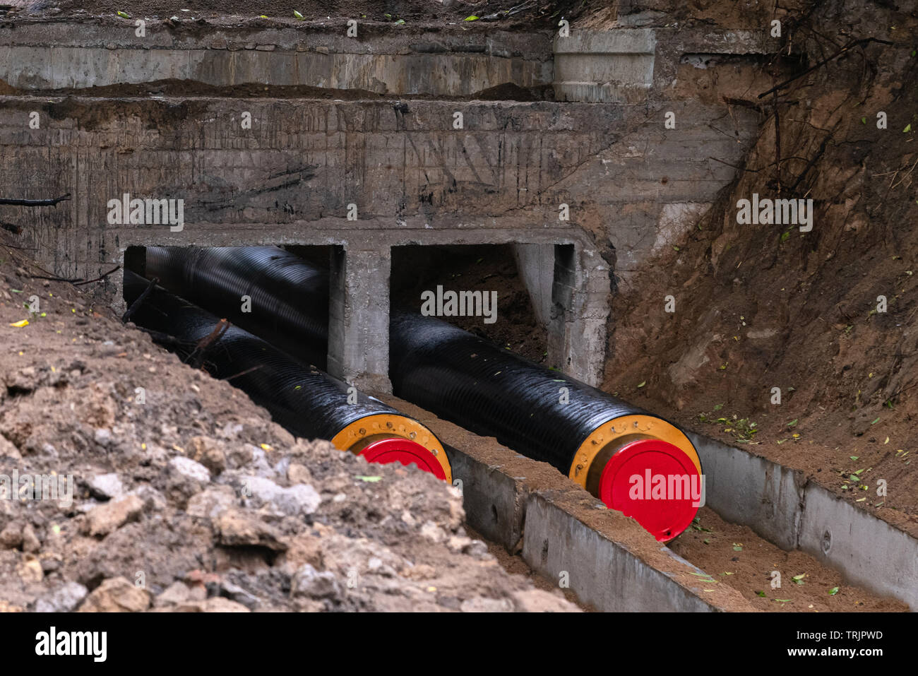 New water pipes being laid down deep into the ground. Construction site ...