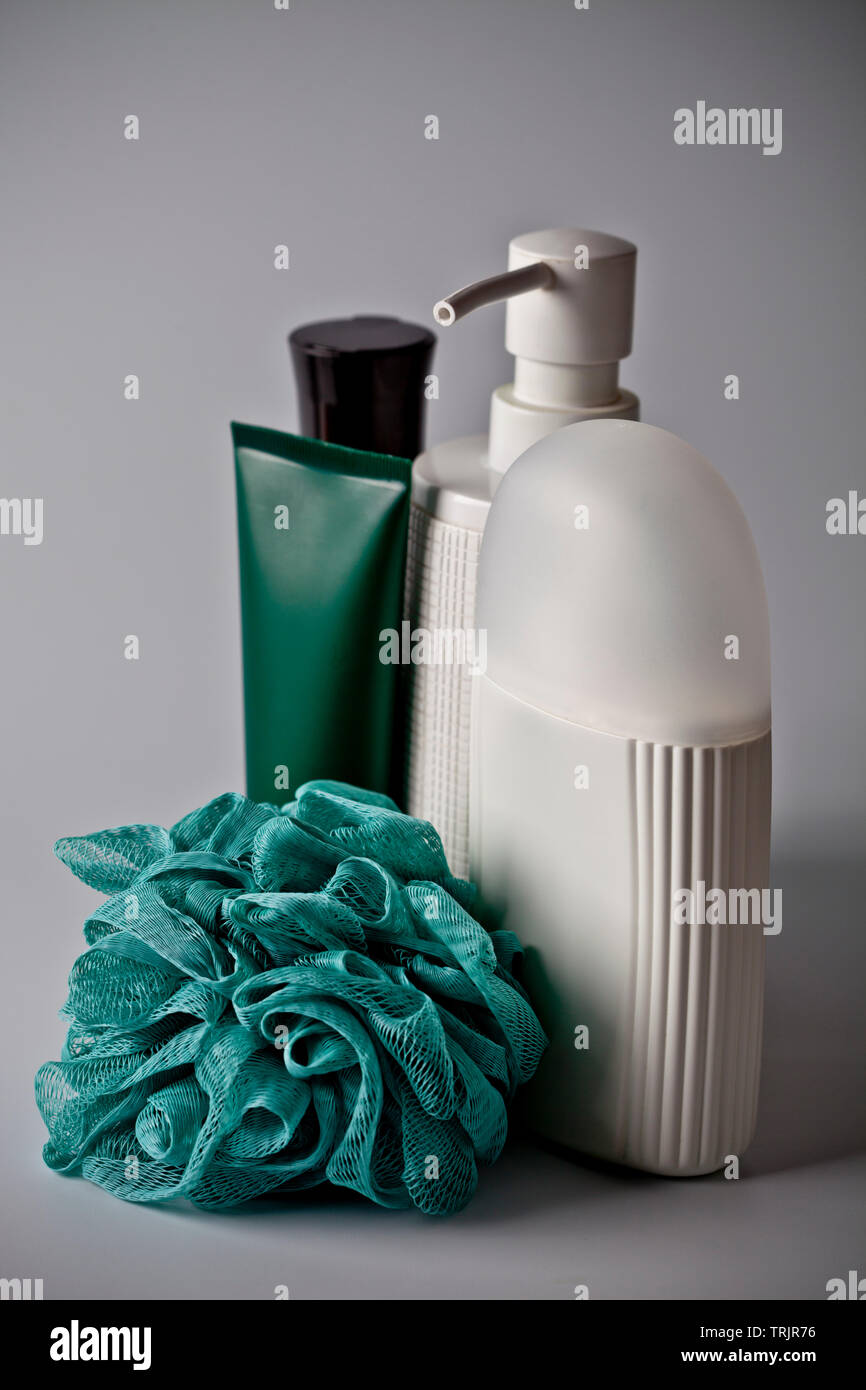 Bath cosmetic products: liquid soap, bath foam, creme and turquoise ...