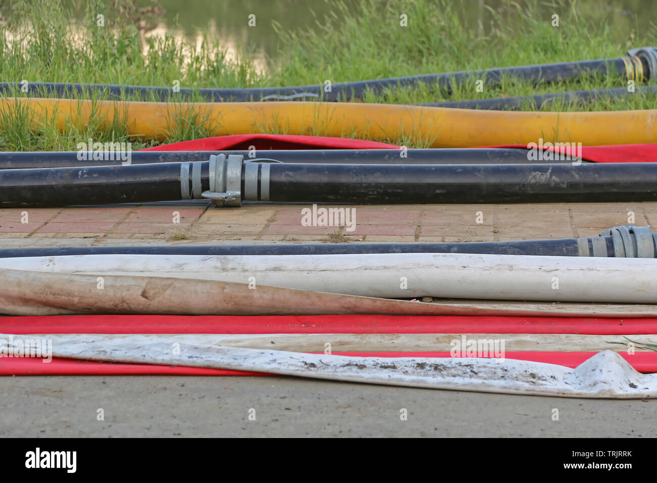 Fire Hoses and Pipes For Pumping Out Floods Water Stock Photo - Alamy