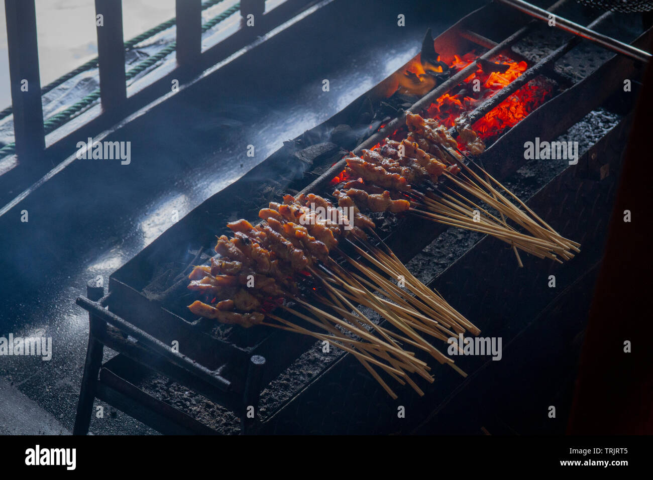 Chicken satay grill at a busy street food market Stock Photo - Alamy