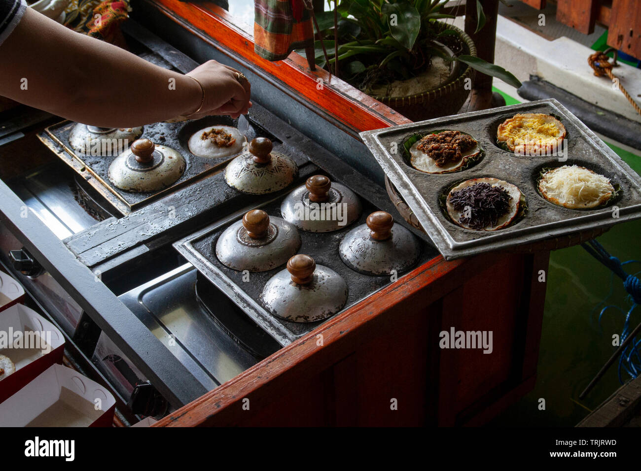 Traditional Indonesian pancake or serabi at a busy street food market ...